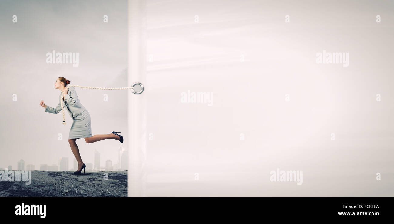 Young businesswoman running and pulling white blank banner Stock Photo ...