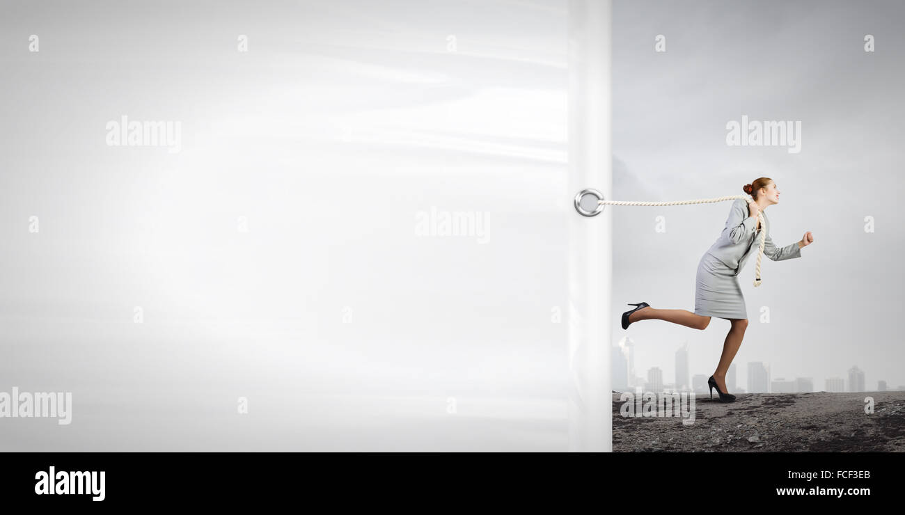 Young businesswoman running and pulling white blank banner Stock Photo ...