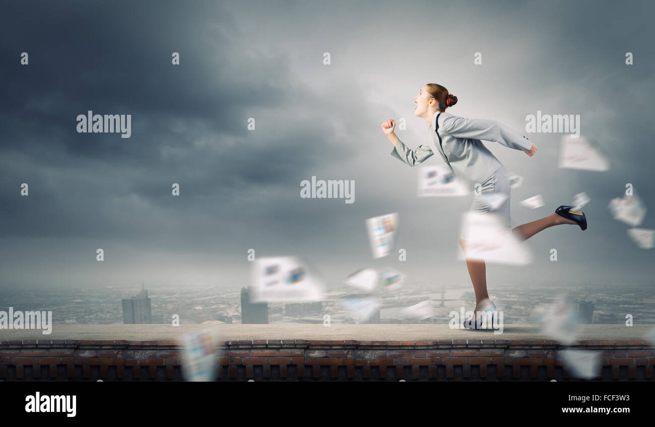Young businesswoman in suit running in a hurry Stock Photo - Alamy