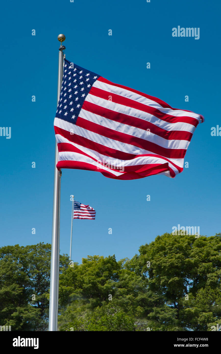 Two American flags flying in the breeze Stock Photo - Alamy