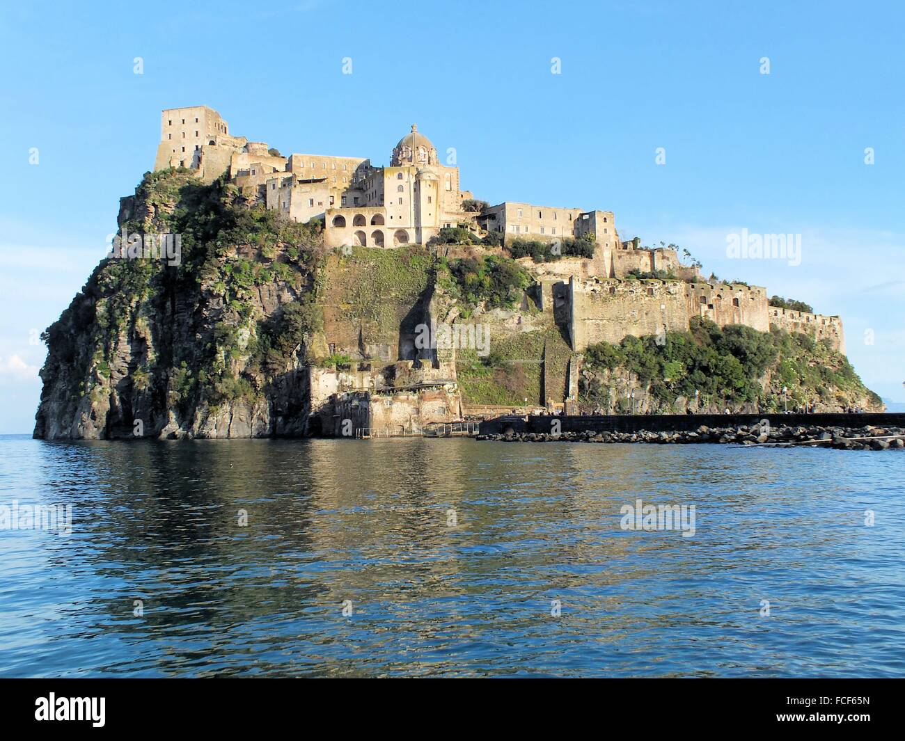 The Aragonese Castle is located on a small rocky island across from ...