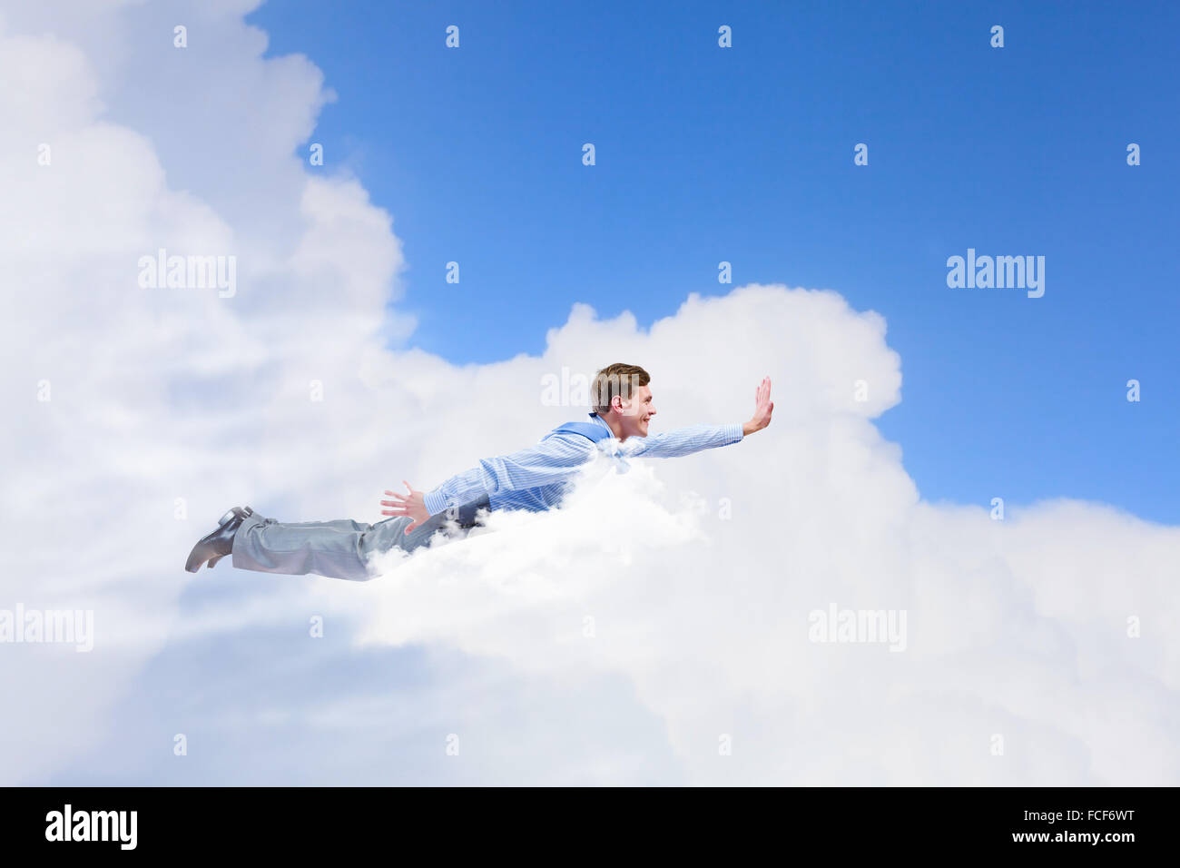 Young businessman superhero flying high in sky Stock Photo - Alamy
