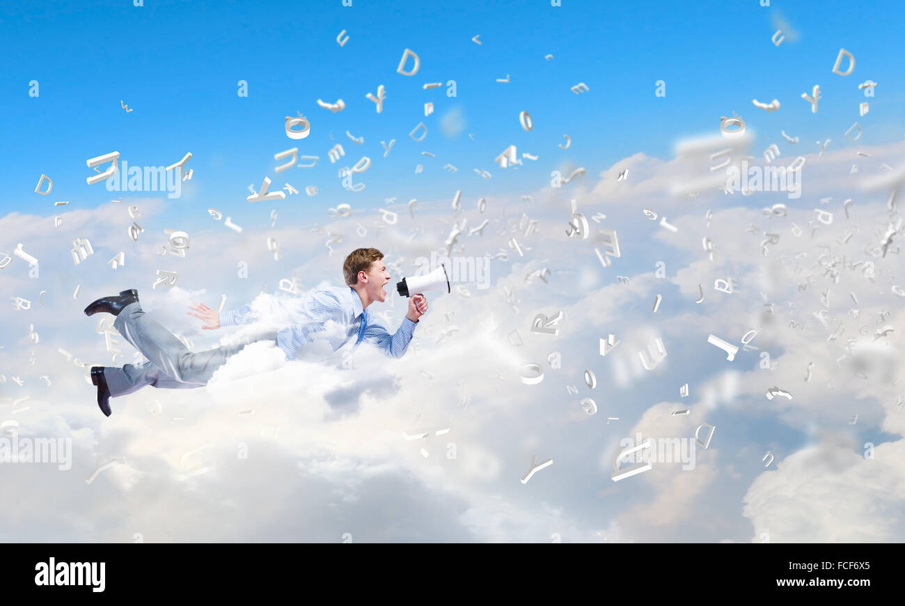 Young man flying in sky and screaming in megaphone Stock Photo - Alamy
