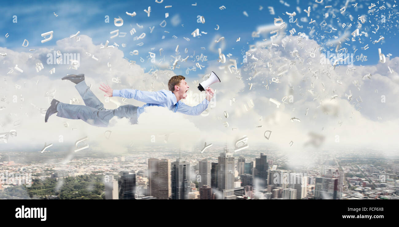 Young man flying in sky and screaming in megaphone Stock Photo - Alamy