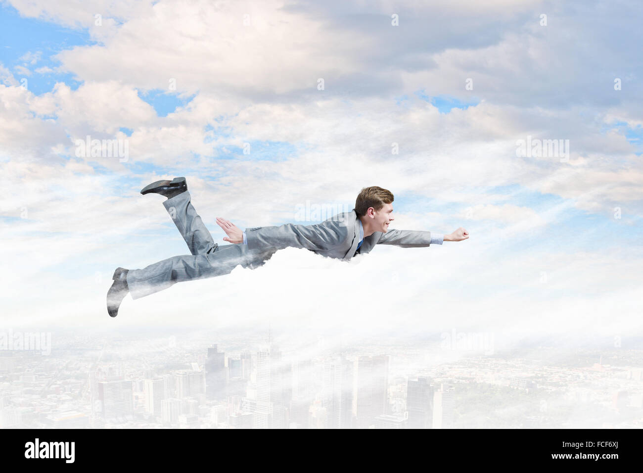 Young businessman superhero flying high in sky Stock Photo - Alamy