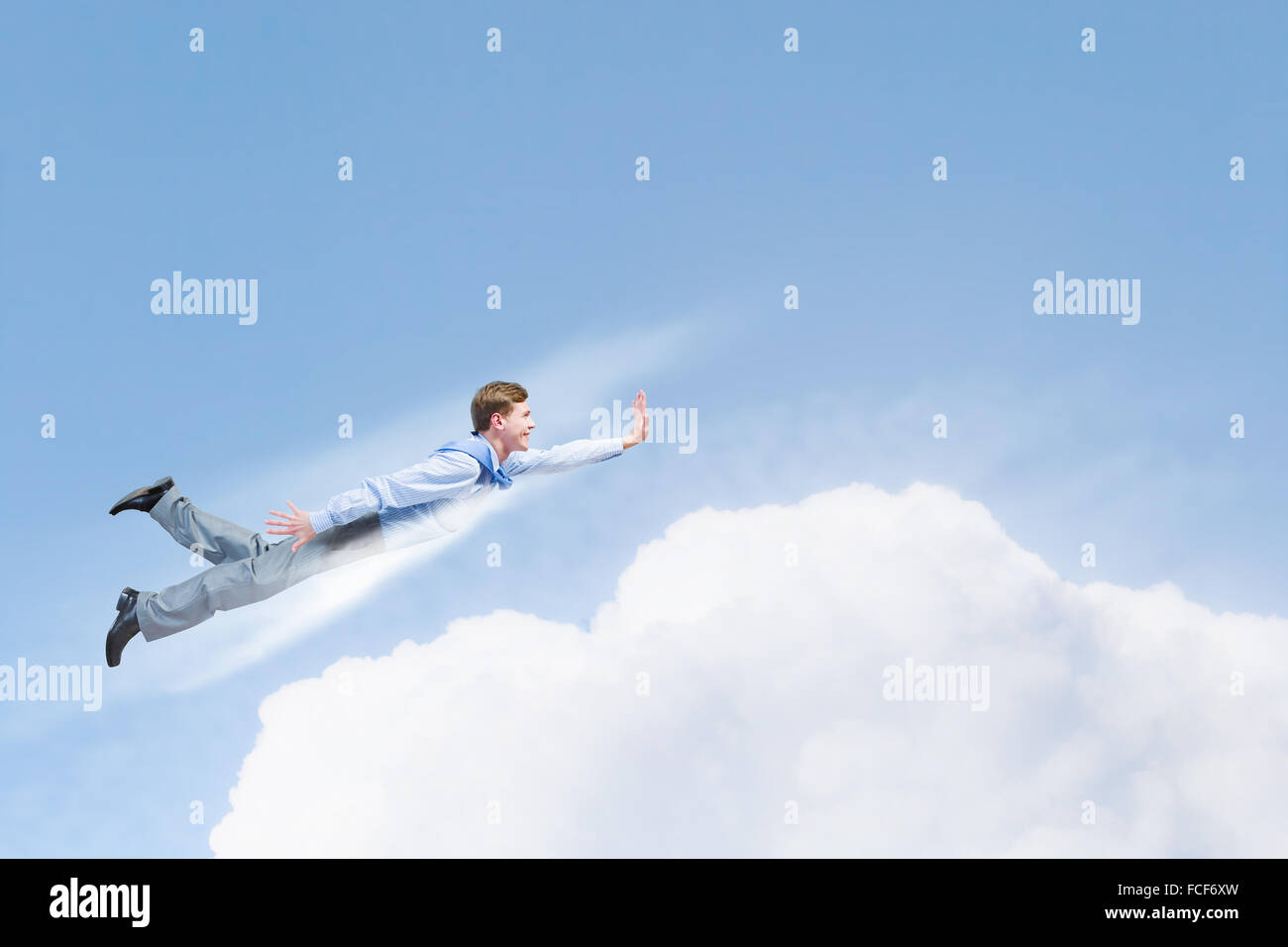 Young businessman superhero flying high in sky Stock Photo - Alamy