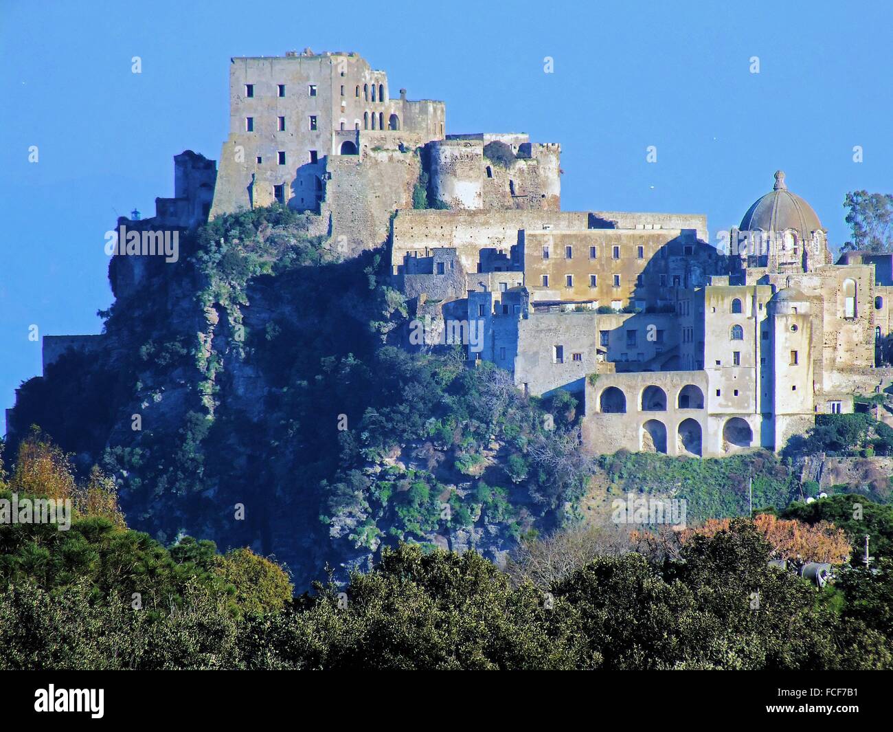The Aragonese Castle is located on a small rocky island opposite of ...