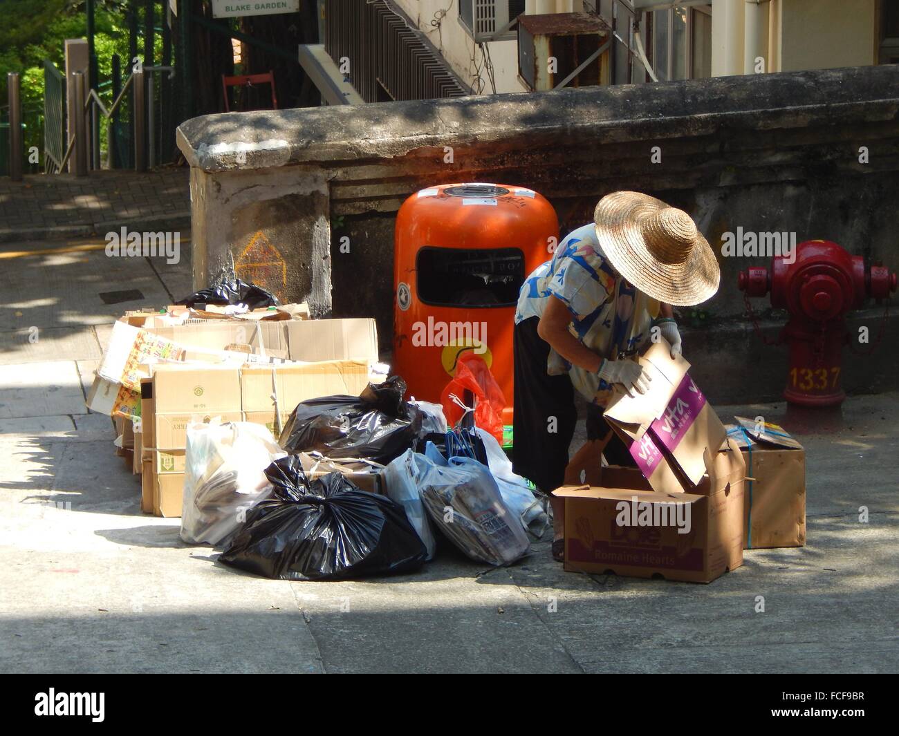 Recycling in Sheung Wan - Hong Kong Island - an old woman collect waste ...