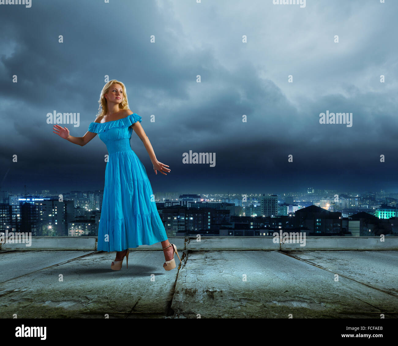 Anxious young woman in blue dress looking back worried Stock Photo - Alamy