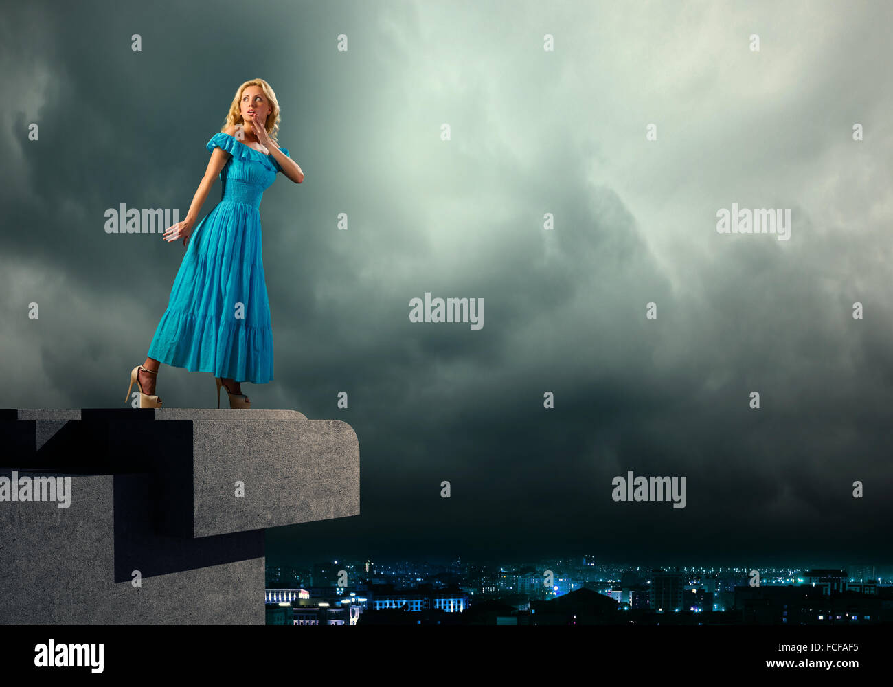Anxious young woman in blue dress looking back worried Stock Photo - Alamy