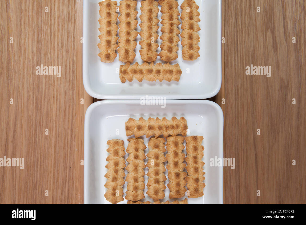 Biscuits in ceramic bowls on a wooden tray Stock Photo - Alamy