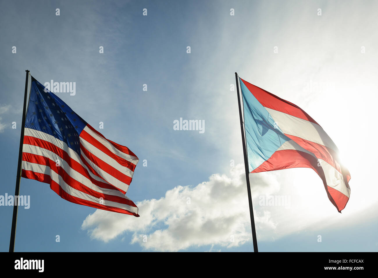 Puertorican and American flag waving against bright sky. Arroyo, Puerto ...