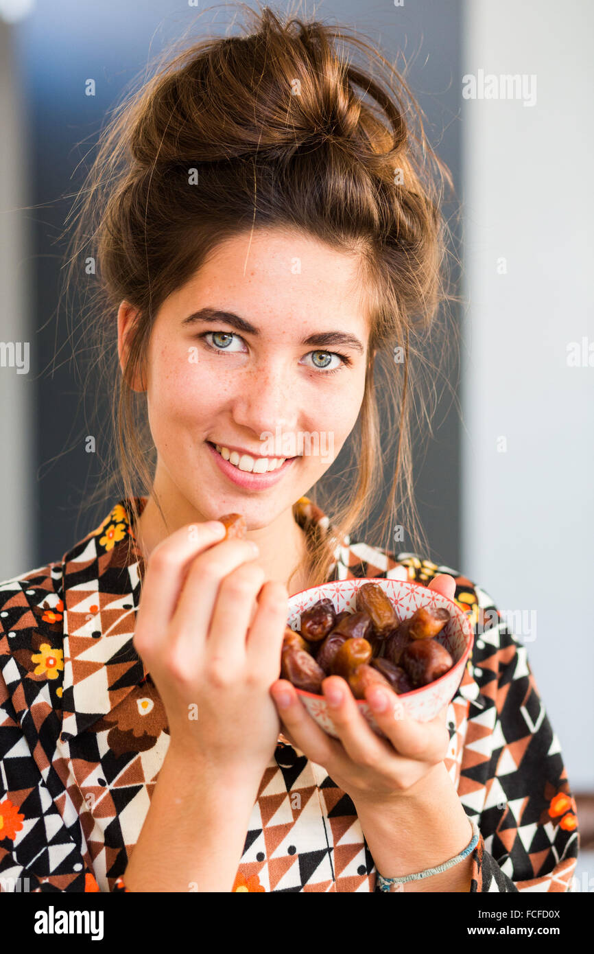Woman eating pitted dates Stock Photo - Alamy