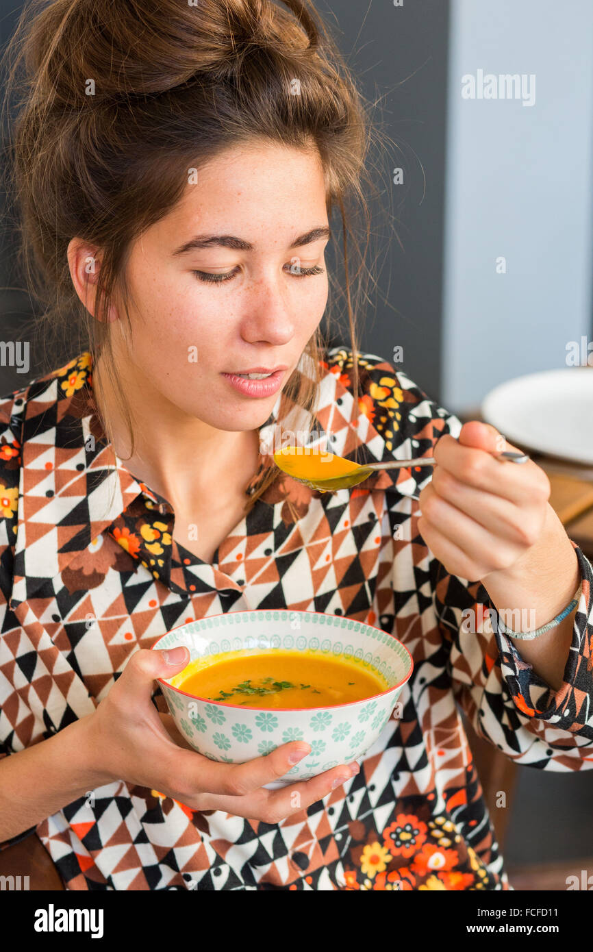 Woman eating a soup Stock Photo - Alamy