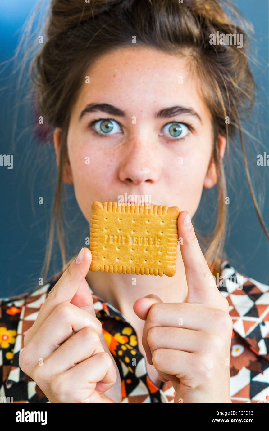 Woman eating cookies Stock Photo - Alamy
