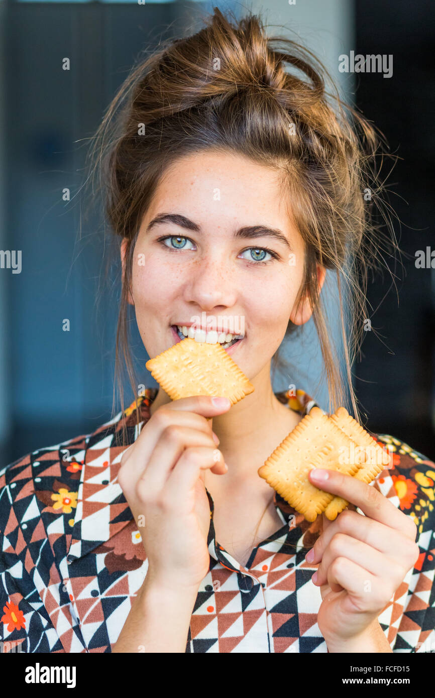Woman eating cookies Stock Photo - Alamy