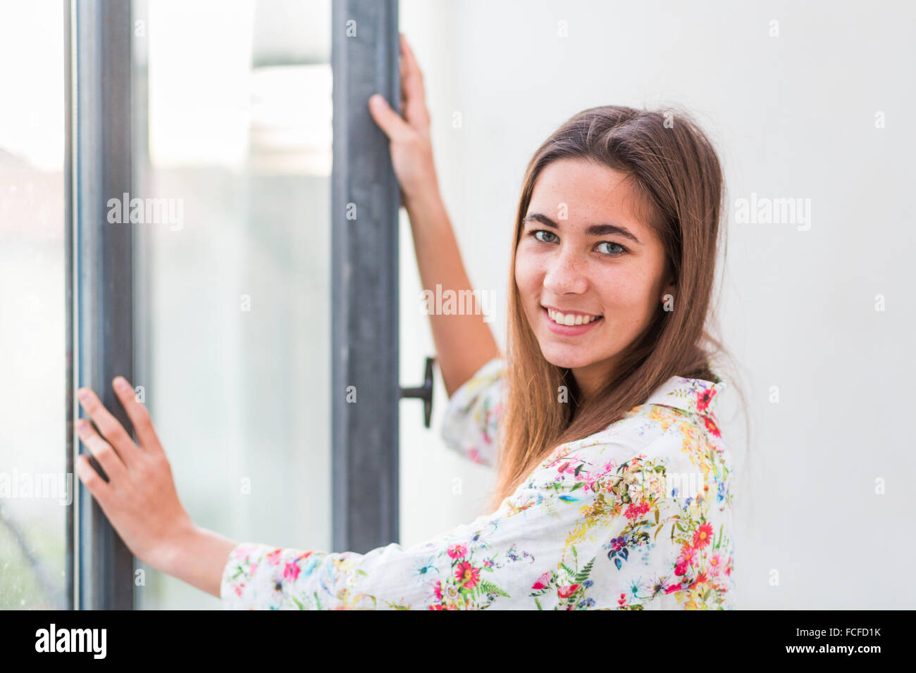 Woman opening window Stock Photo - Alamy