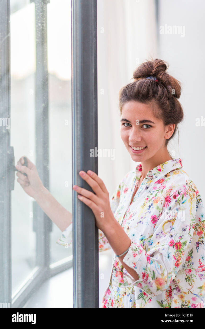 Woman opening window Stock Photo - Alamy