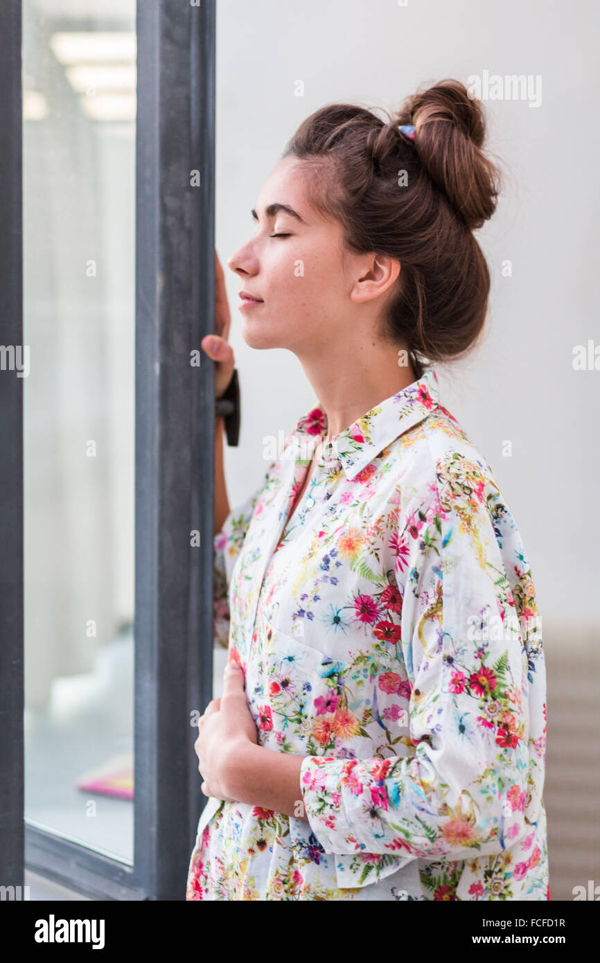 Woman opening window Stock Photo - Alamy