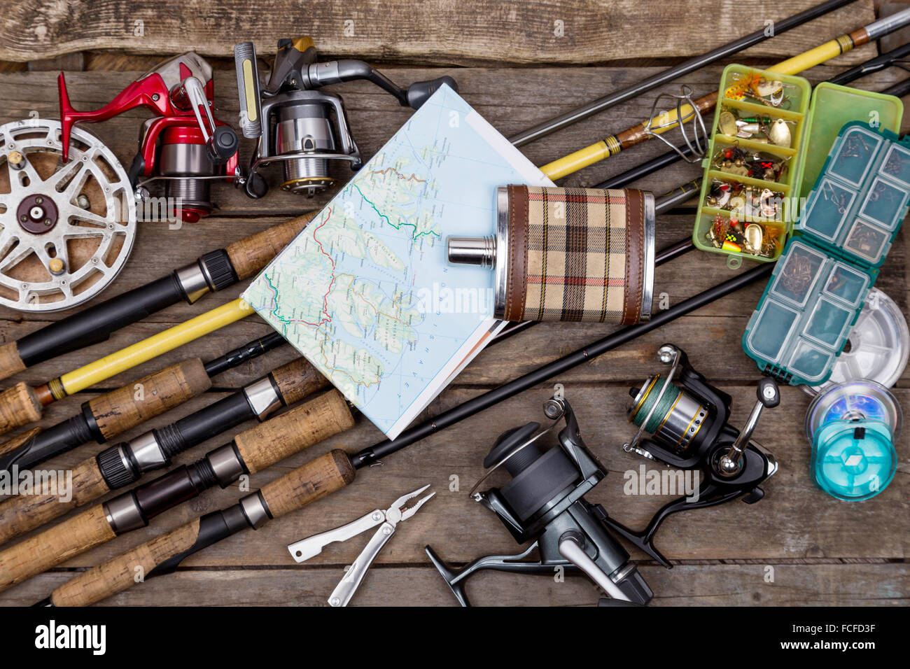 different fishing rods and reels on wooden boards background Stock ...