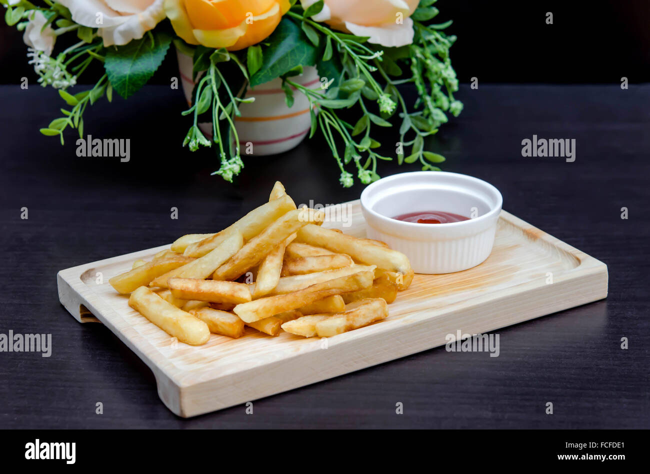 Traditional French fries on wooden plate with tomato sauce Stock Photo ...