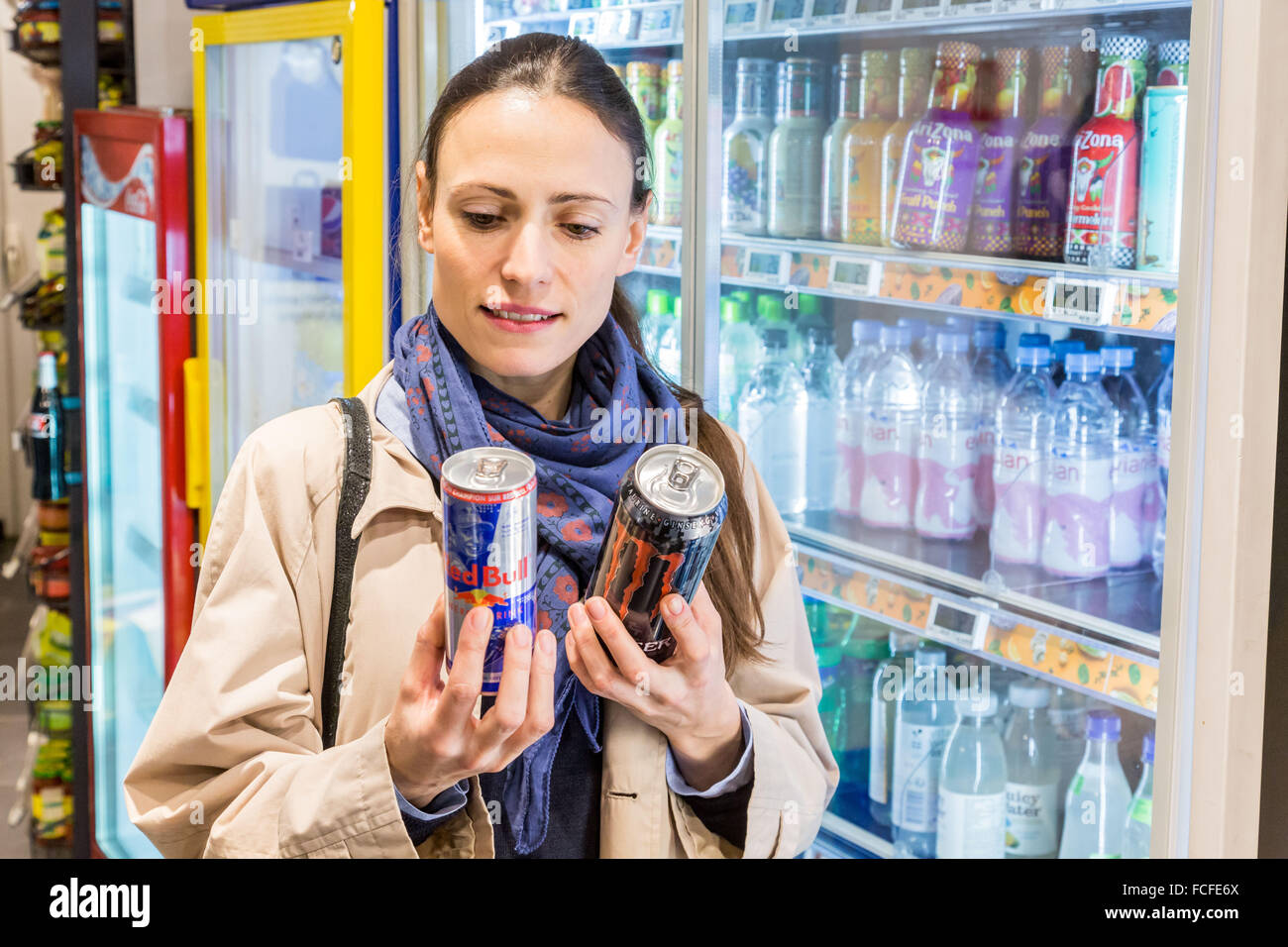 Woman shopping for energy drinks in supermarket Stock Photo - Alamy