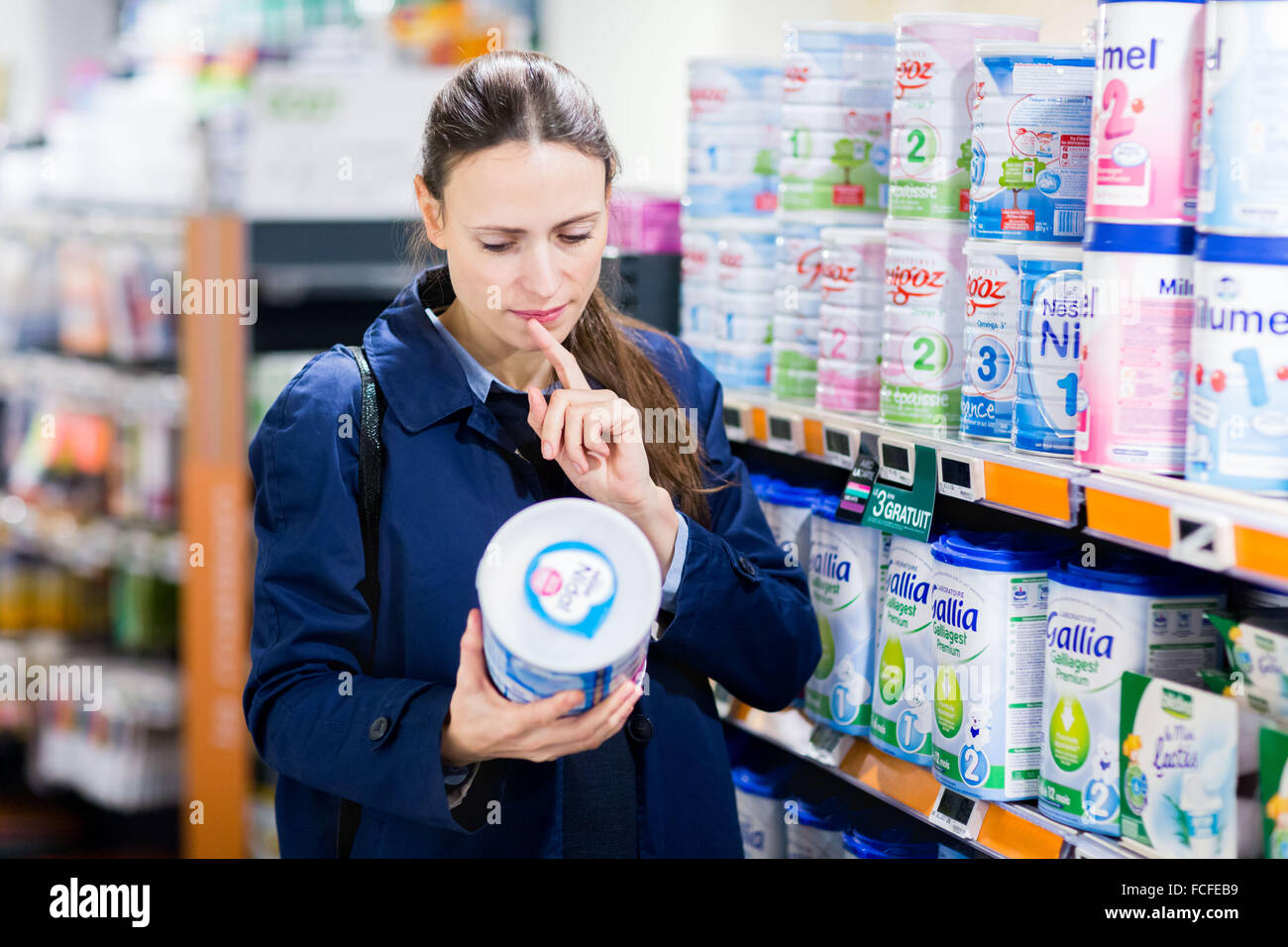 Woman shopping in baby food section in supermarket Stock Photo - Alamy