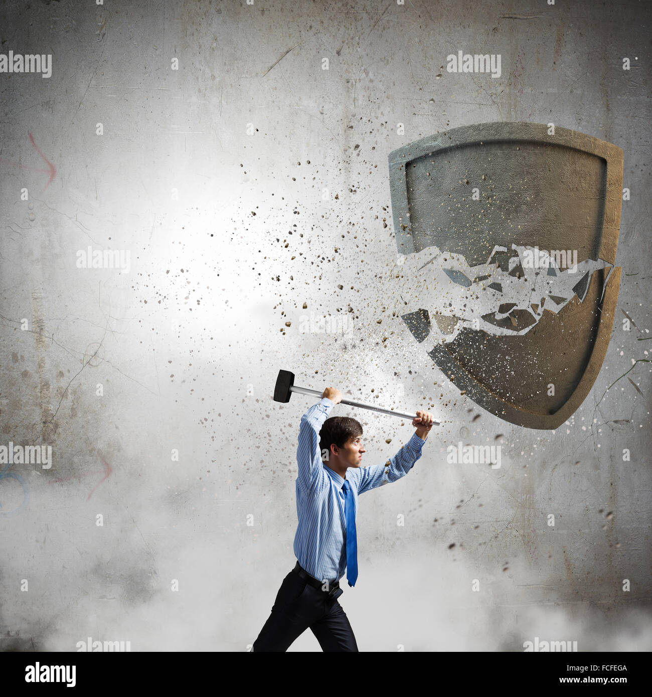 Young businessman crashing stone shield with hammer Stock Photo - Alamy
