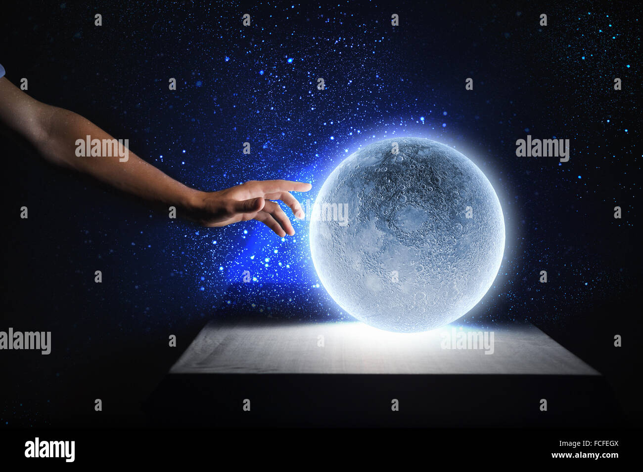 Close of man hands touching moon planet Stock Photo - Alamy
