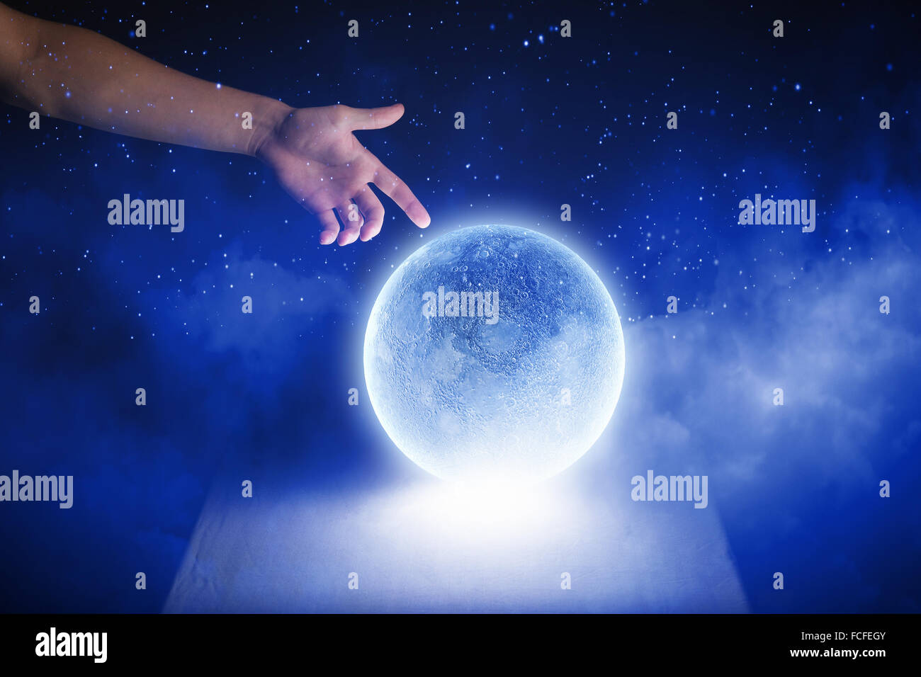 Close of man hands touching moon planet Stock Photo - Alamy