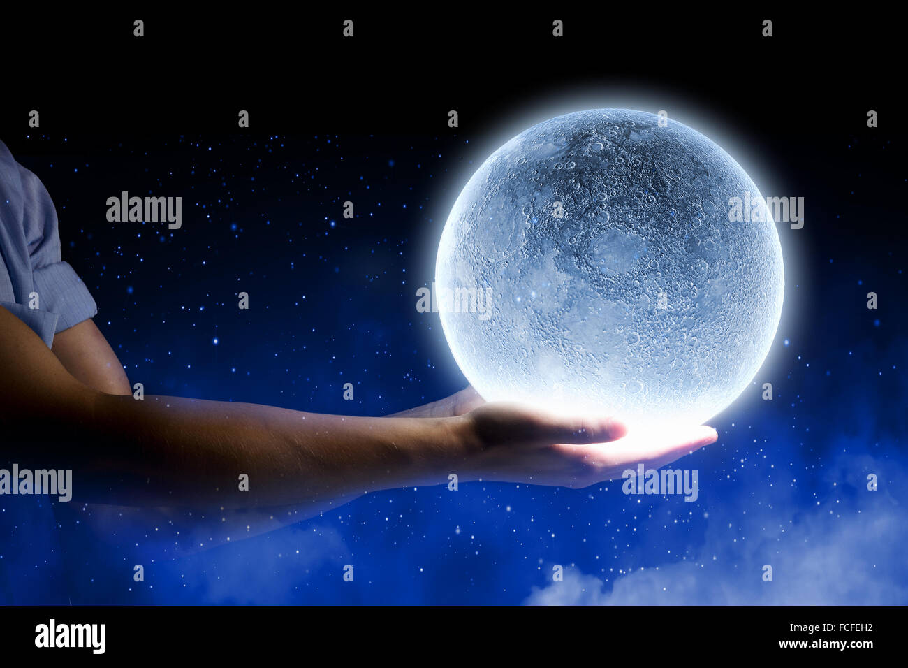 Close of man hands holding moon planet Stock Photo - Alamy