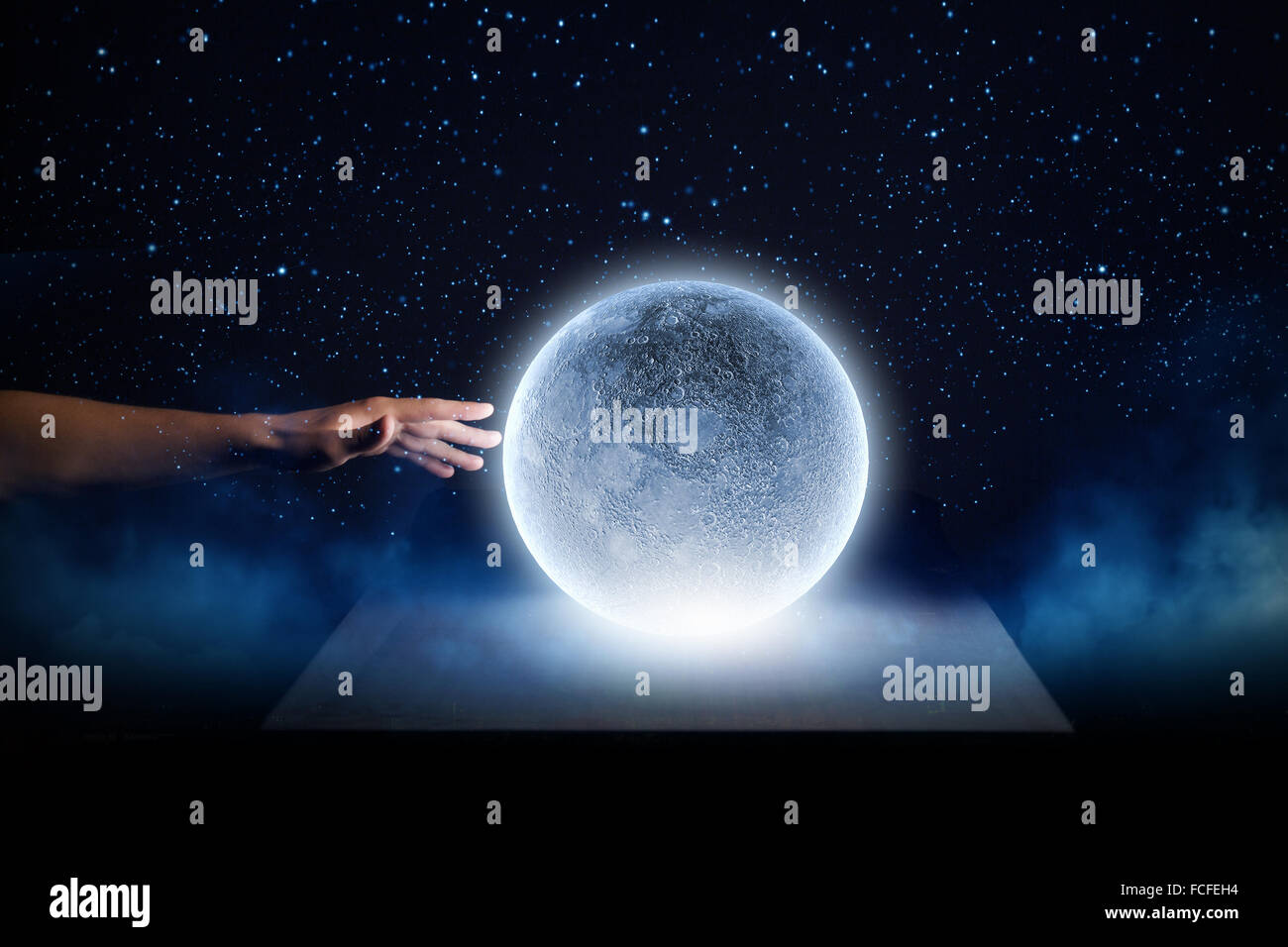 Close of man hands touching moon planet Stock Photo - Alamy