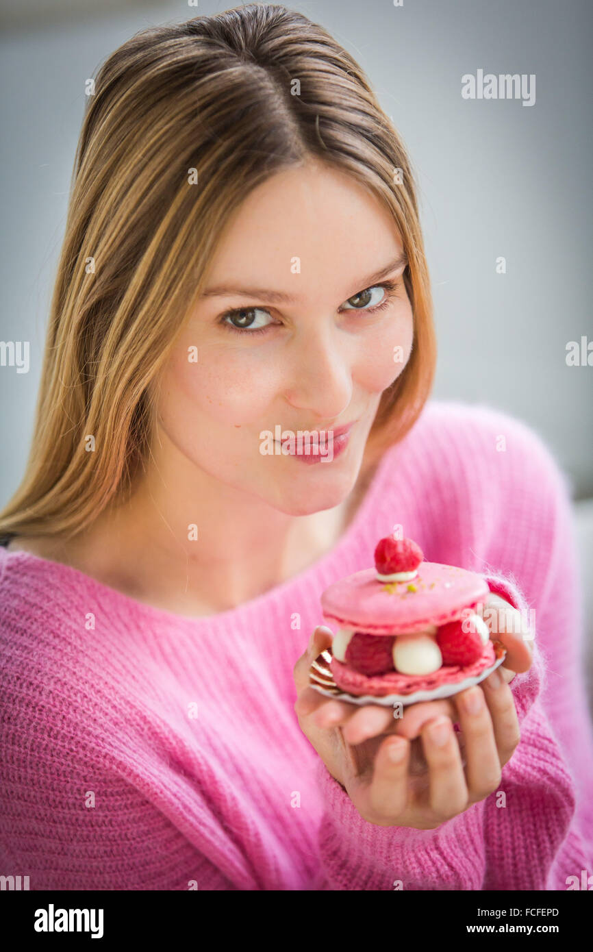 Woman eating pastry Stock Photo - Alamy