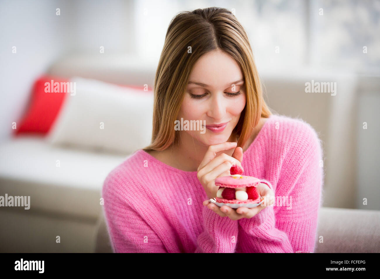 Woman eating pastry Stock Photo - Alamy
