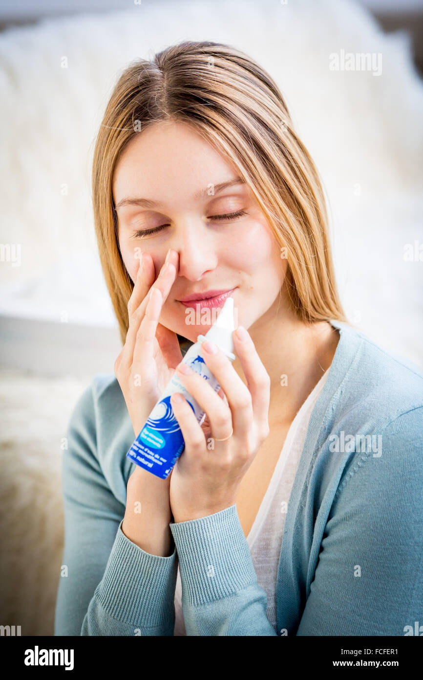 Woman using a sterile sea water spray Stock Photo - Alamy