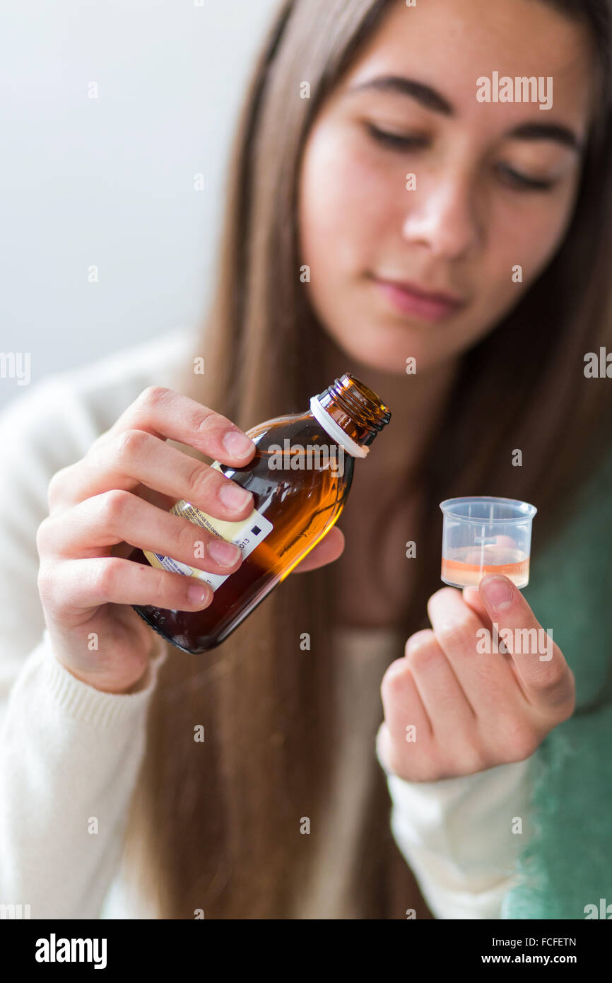Woman taking syrup Stock Photo - Alamy