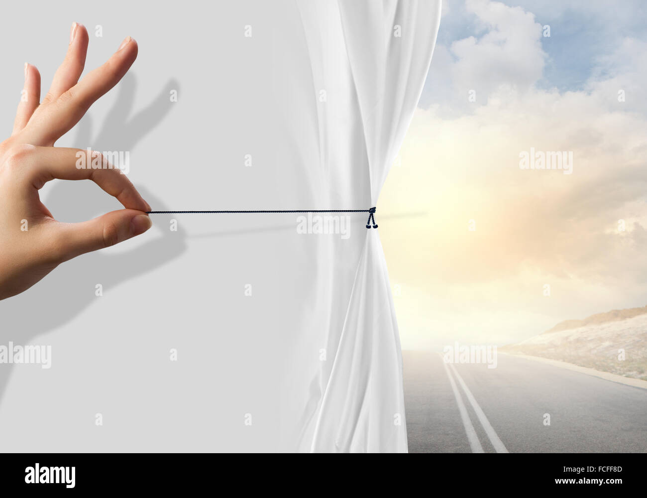 Close up of hand opening curtain with road behind it Stock Photo - Alamy