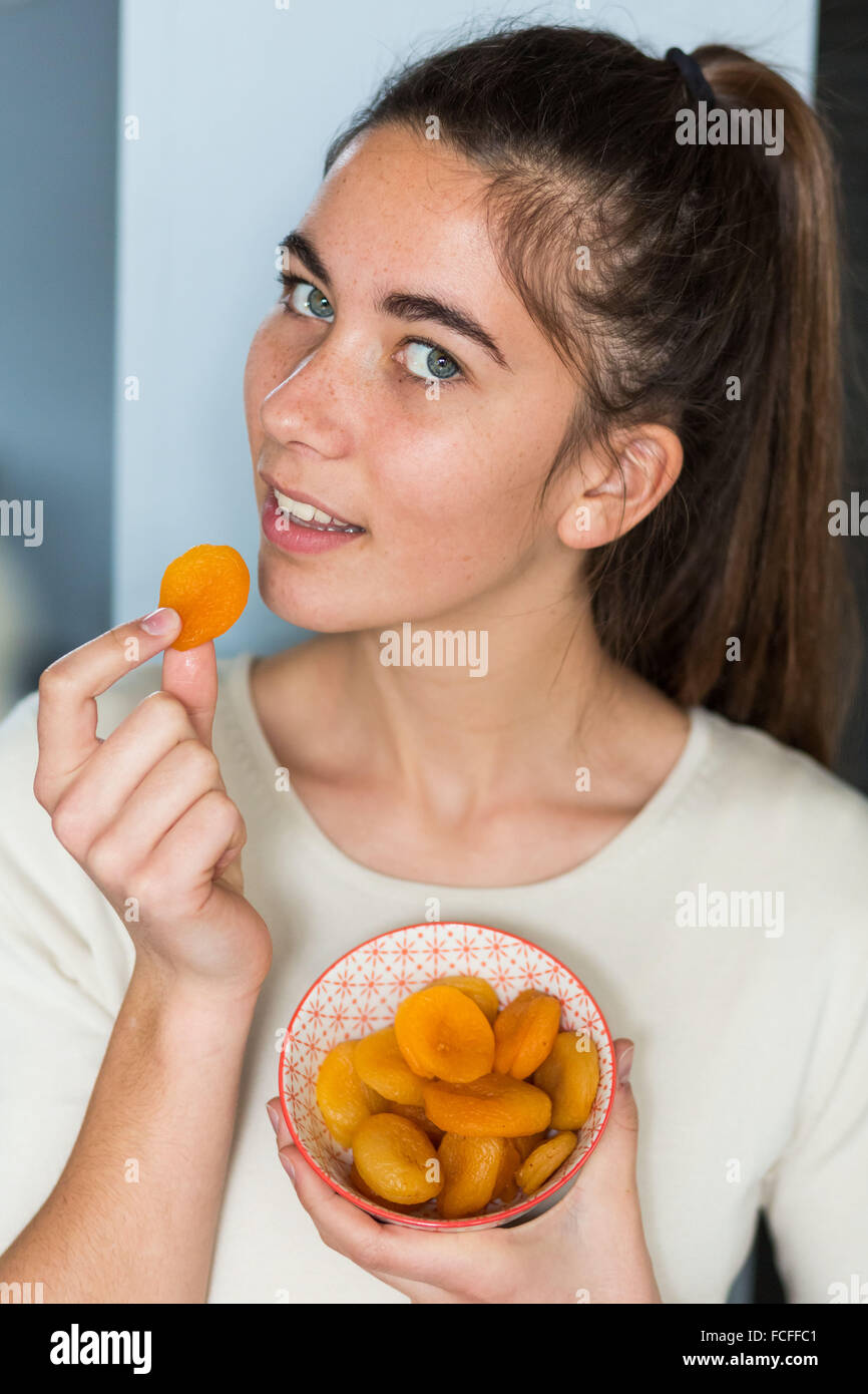 Woman eating dry apricot Stock Photo - Alamy