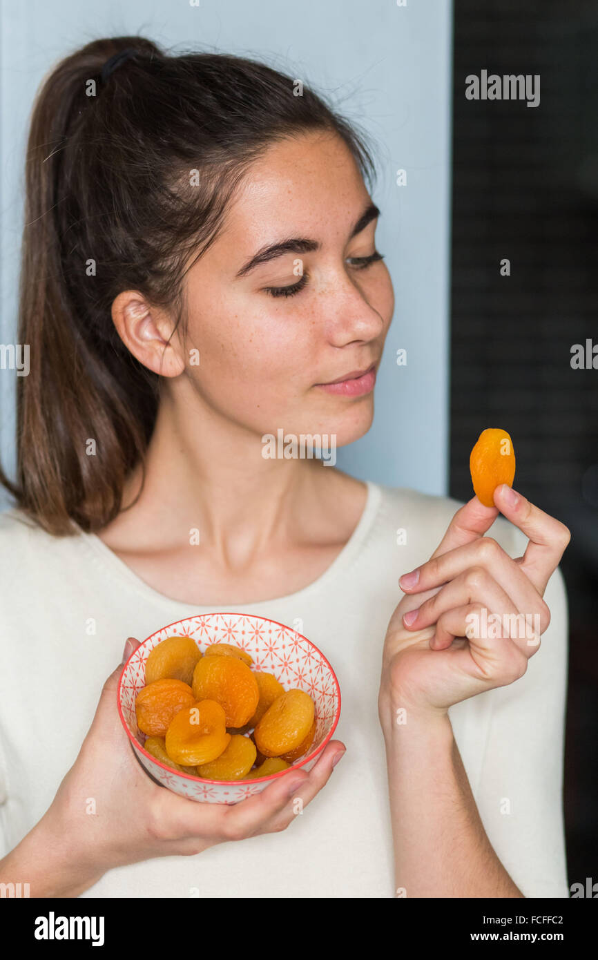 Woman eating dry apricot Stock Photo - Alamy