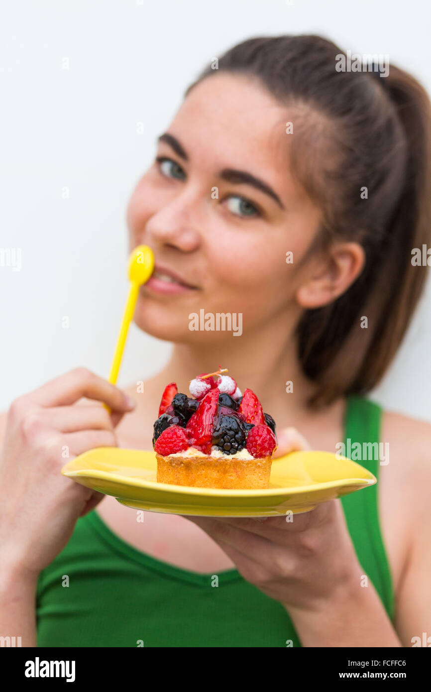 Woman eating pastry Stock Photo - Alamy