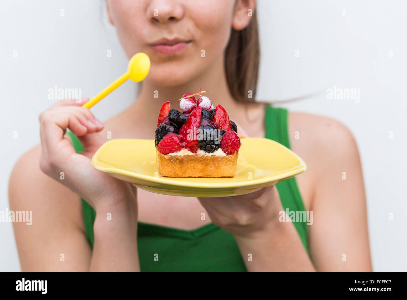 Woman eating pastry Stock Photo - Alamy