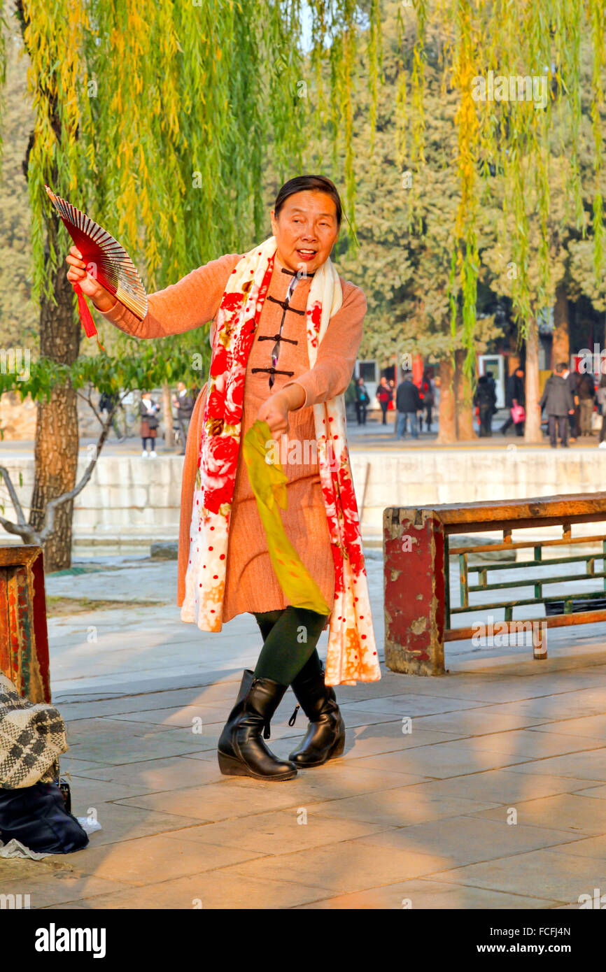Chinese lady in traditional dress performing at the lake at the Summer ...