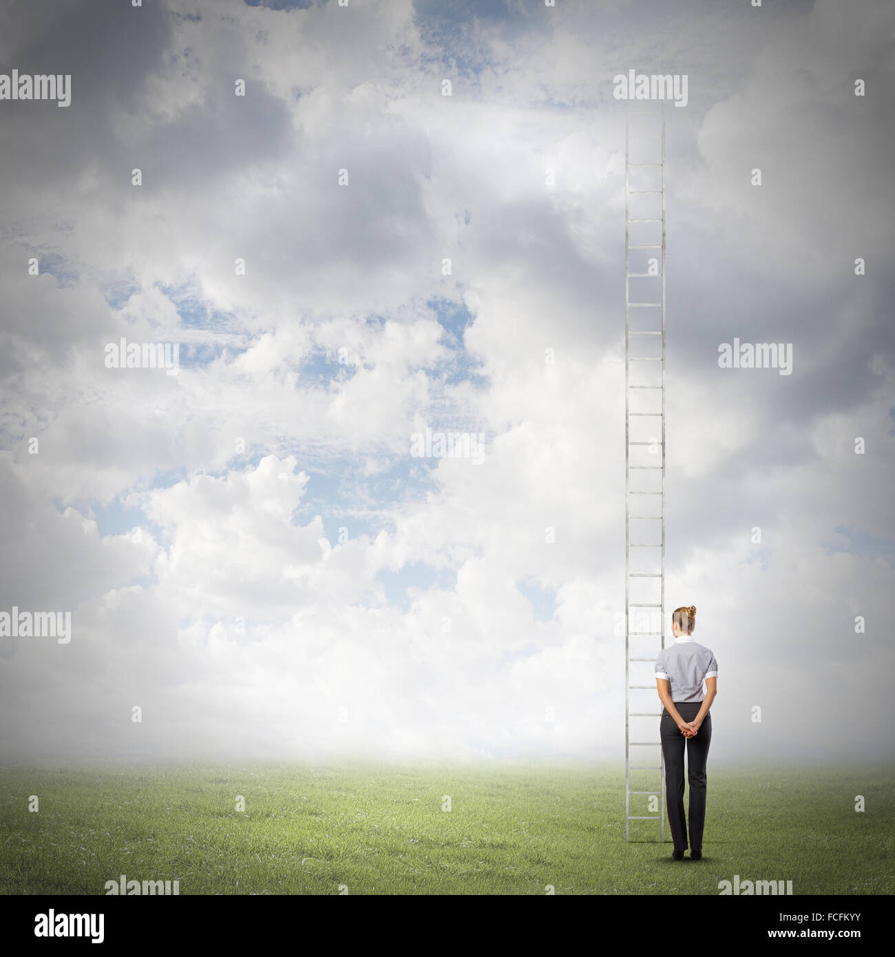 Rear view of businesswoman standing near ladder going high in sky Stock ...