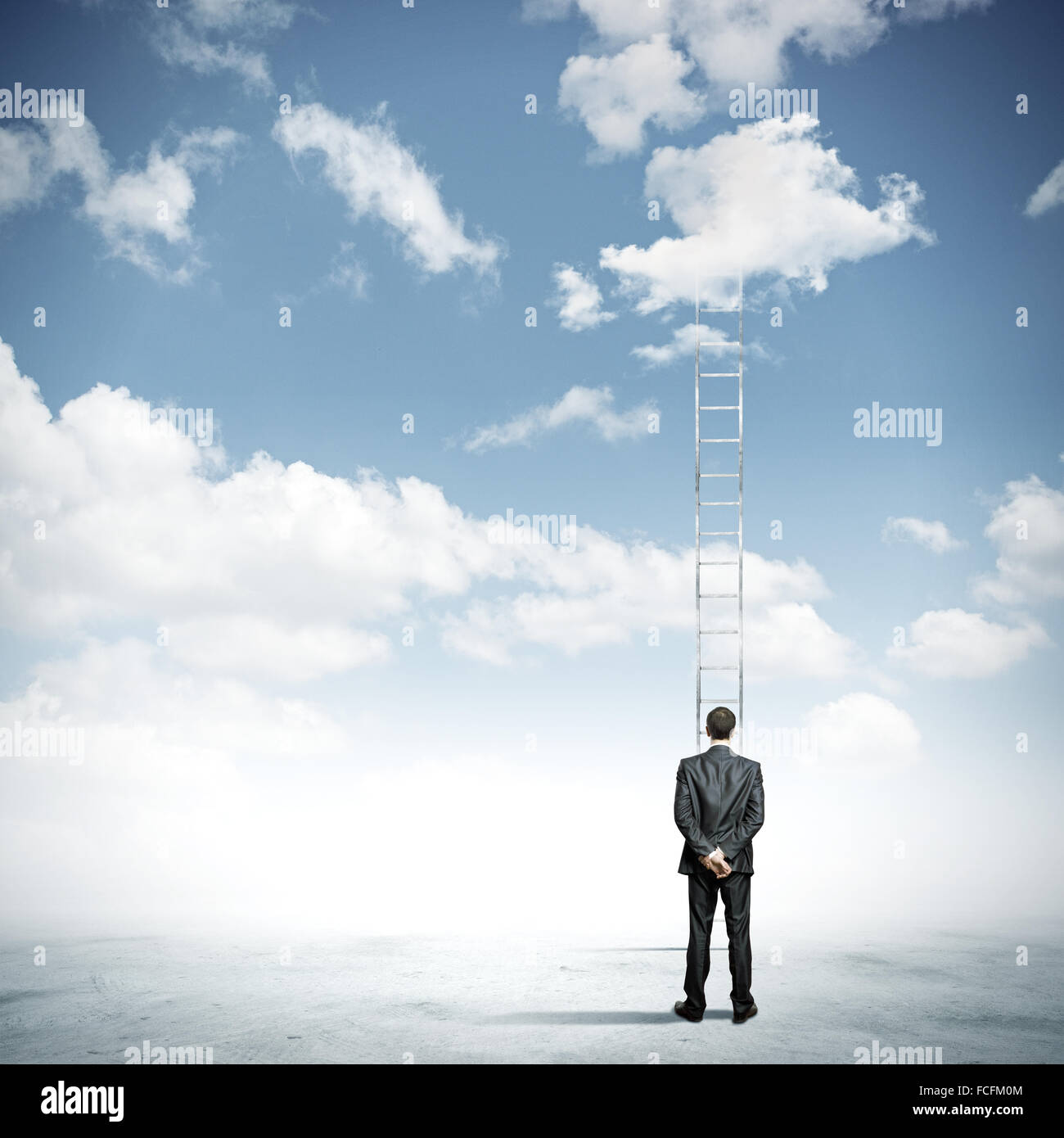 Rear view of businessman standing near ladder going high in sky Stock ...