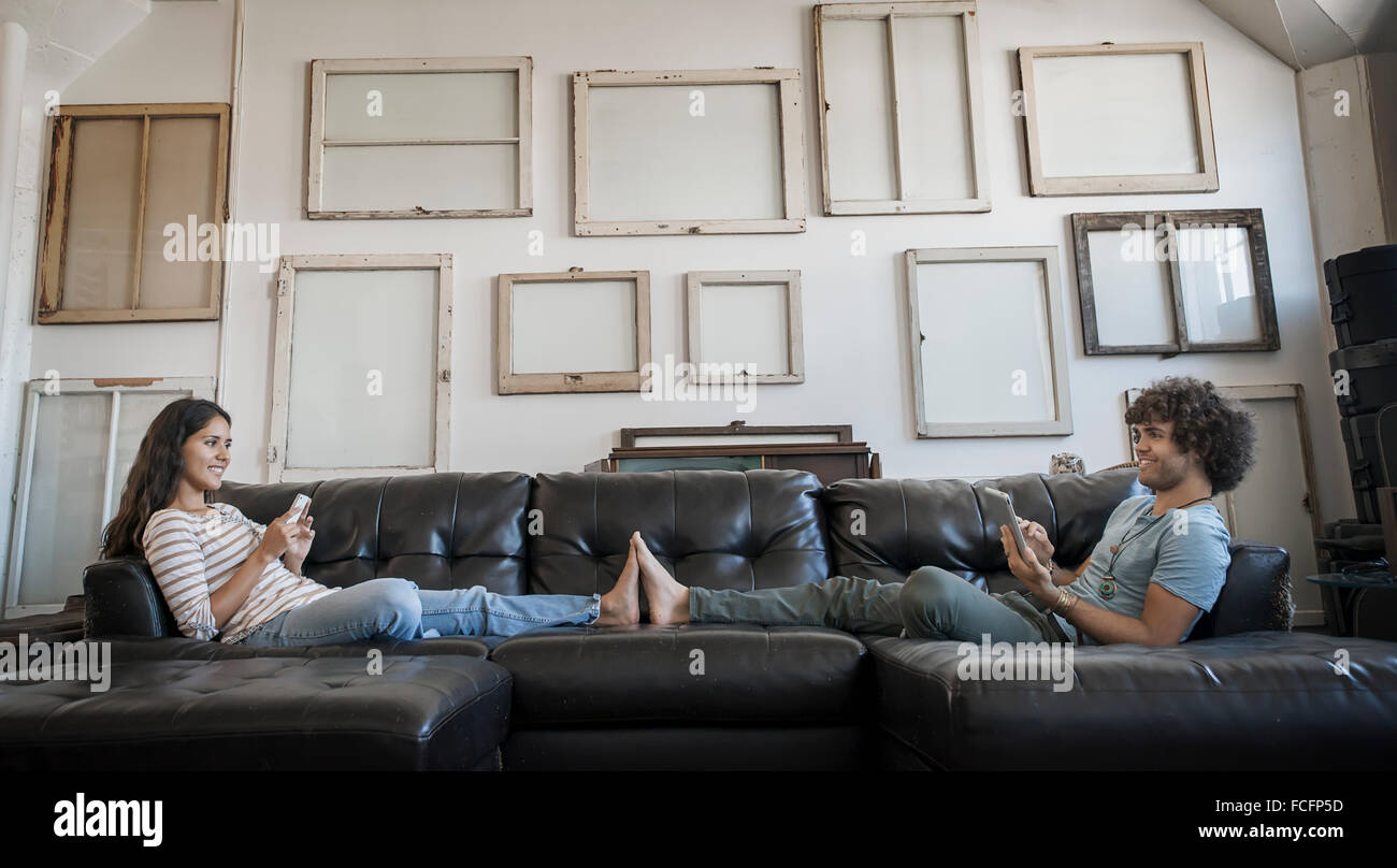 A woman with feet on a sofa hi-res stock photography and images - Alamy