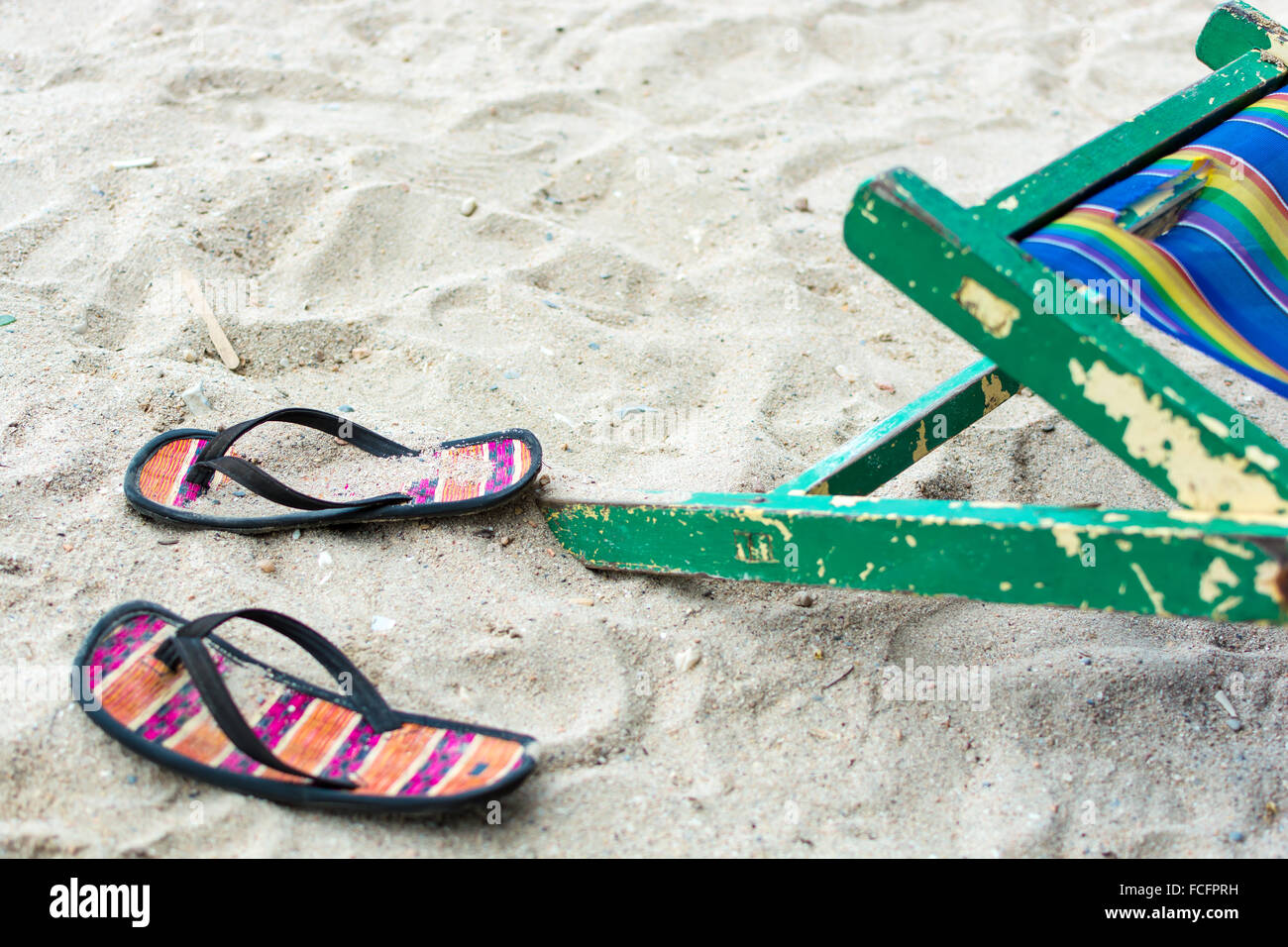 Empty beach chair and flip flops Stock Photo - Alamy