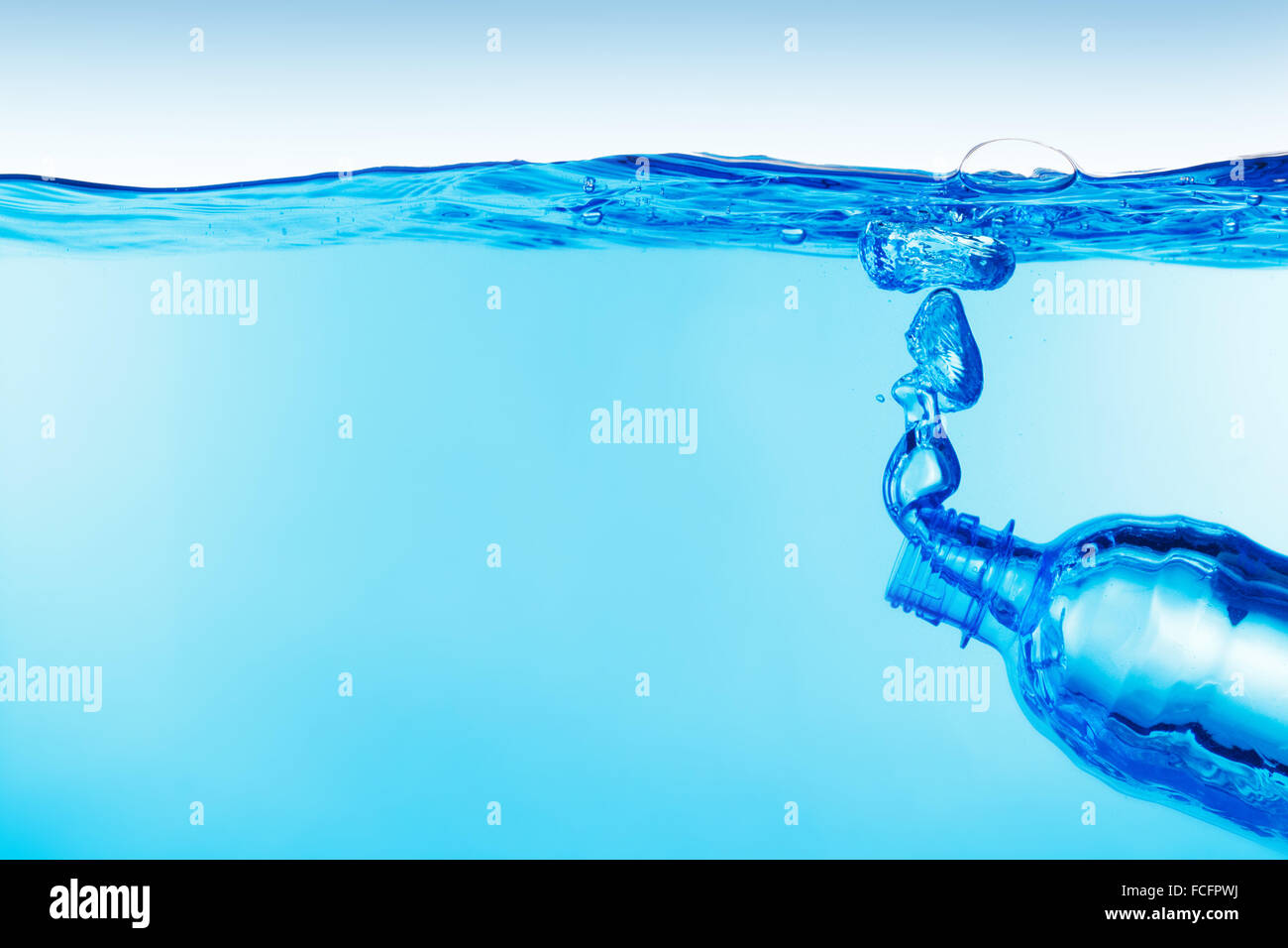 Bottle under water with bubble forming Stock Photo - Alamy
