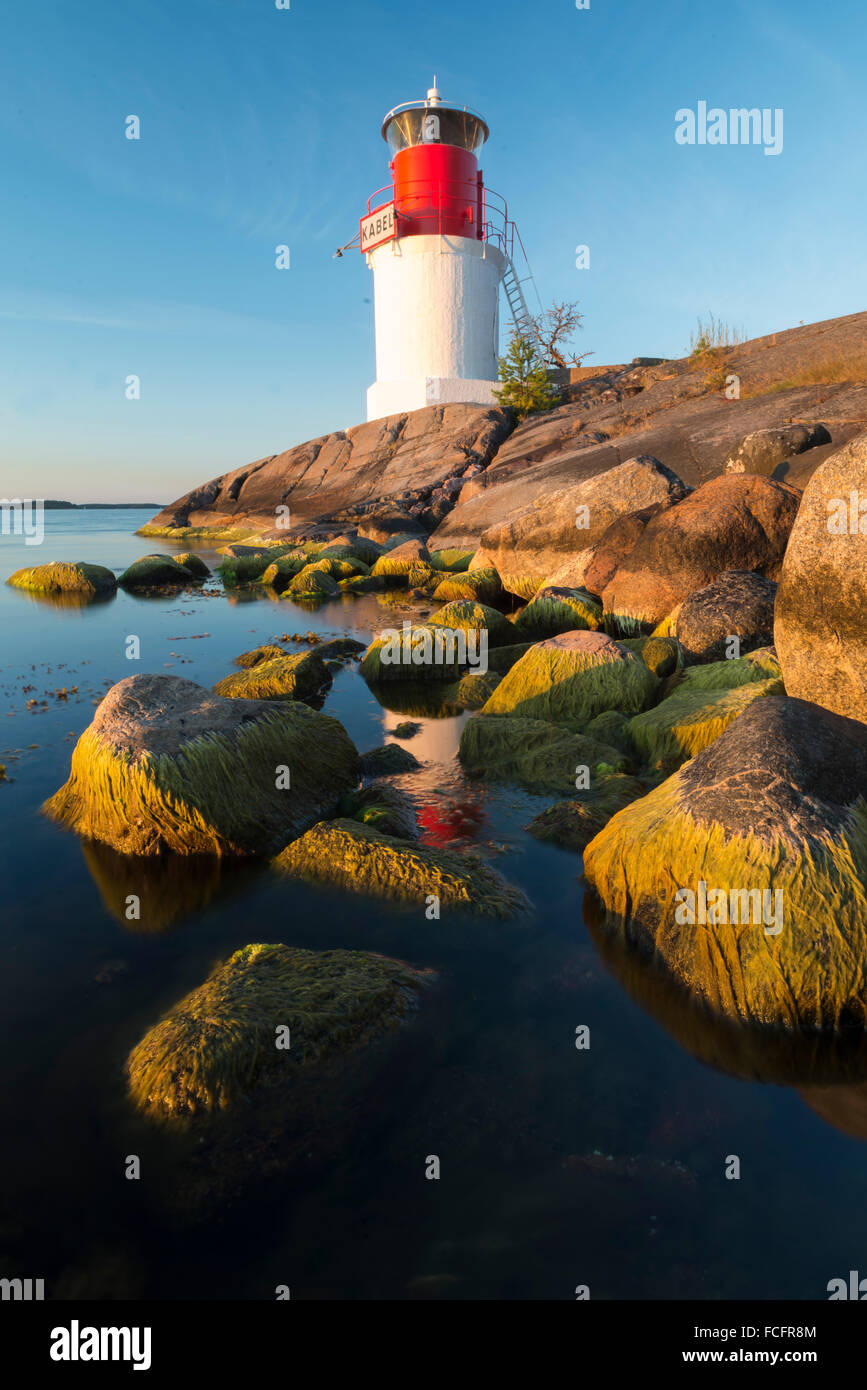 Lighthouse on the rocky coast in the Swedish archipelago island Yxlan ...