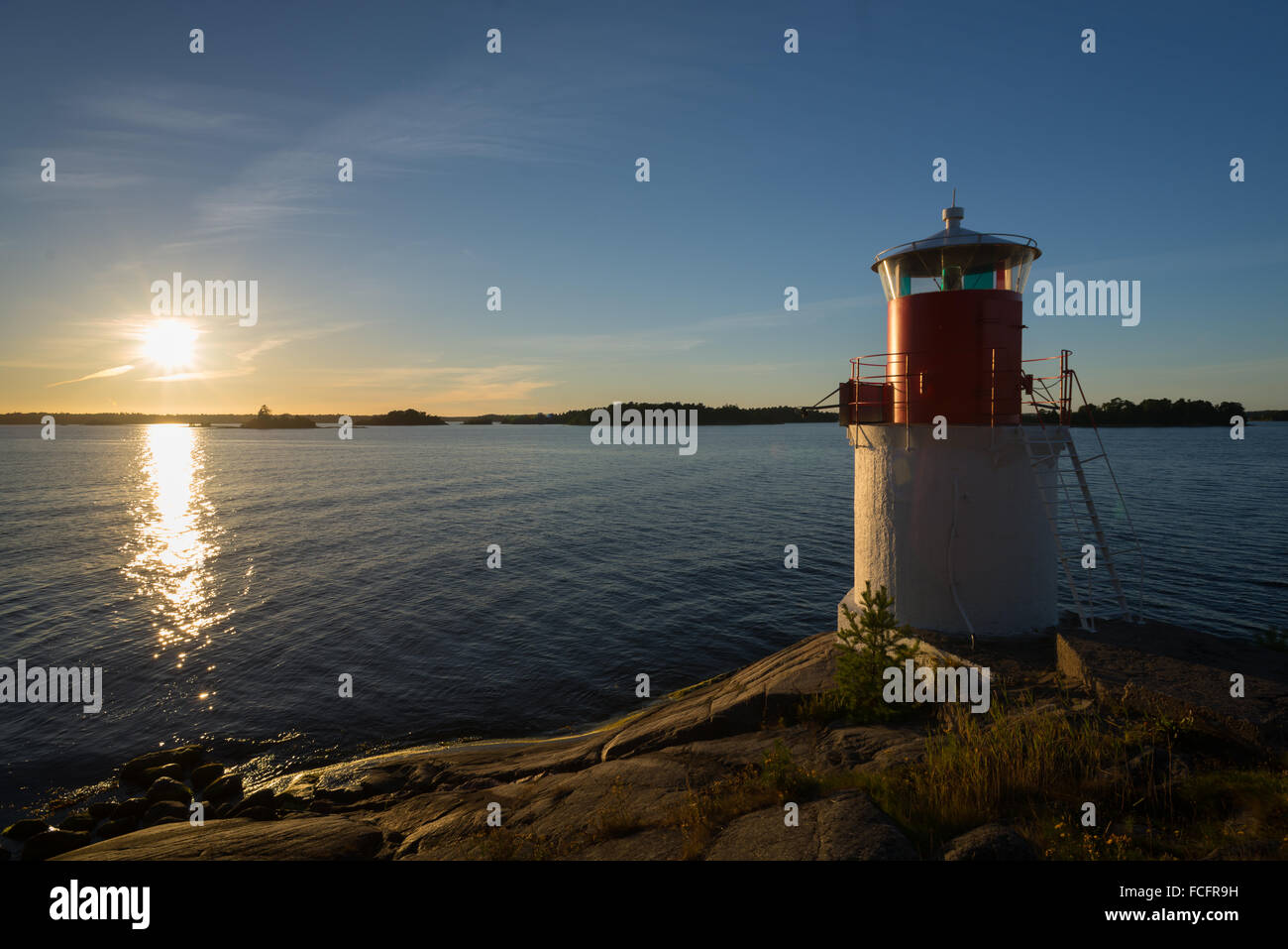 Lighthouse on the rocky coast in the Swedish archipelago island Yxlan ...