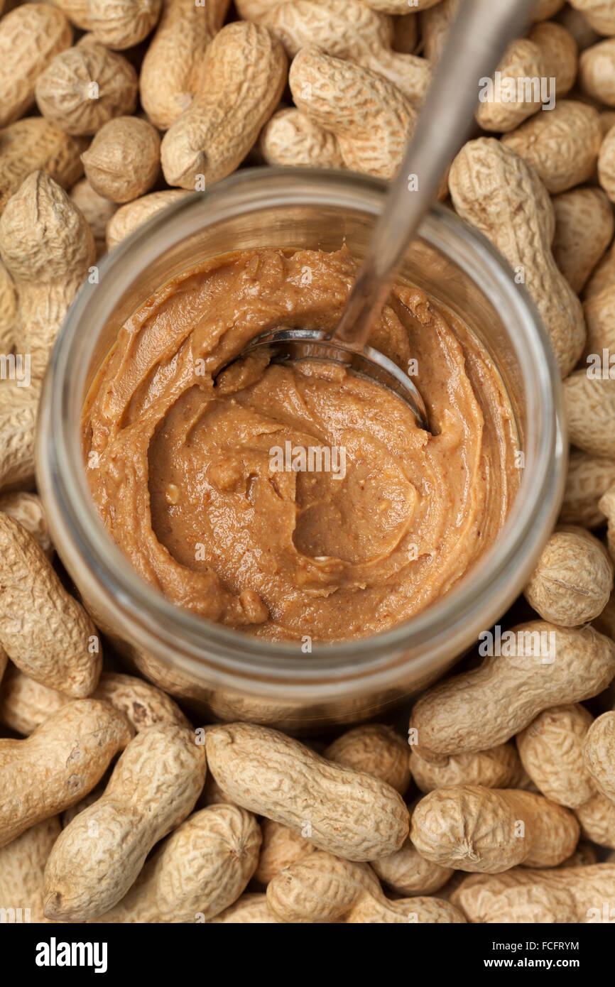 Jar of peanut butter among peanuts Stock Photo - Alamy